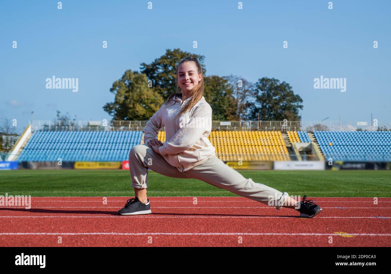 runner prepare for race competition. sprinter warming up on stadium gym ...