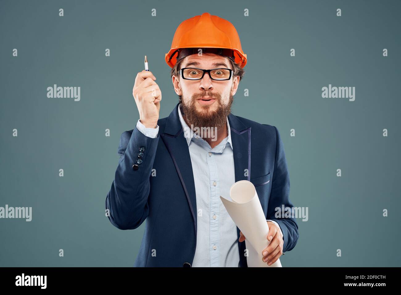 engineer in orange helmets with blueprints in hands construction ...