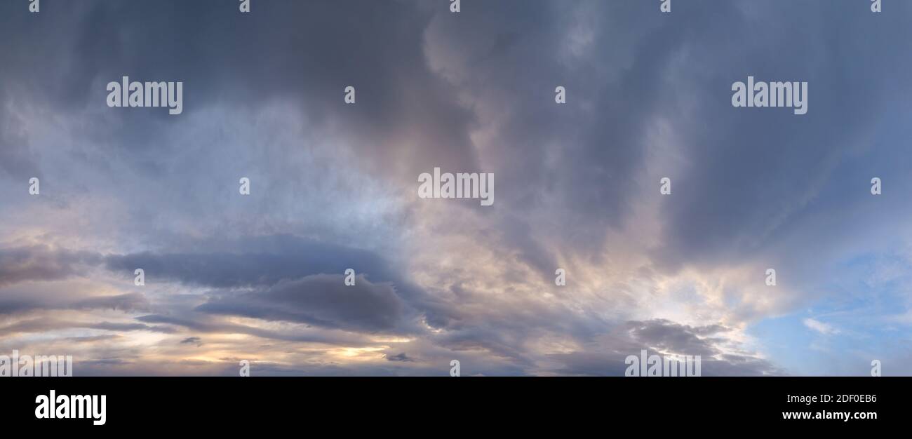 Fluffy clouds in evening overcast sky panoramic view. Climate ...