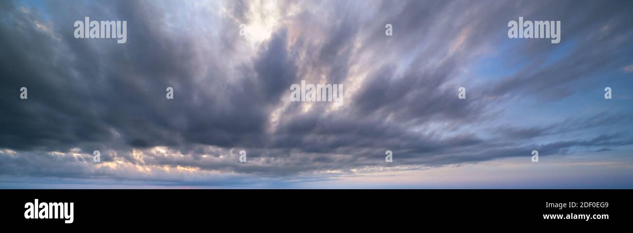 Fluffy clouds in evening overcast sky panoramic view. Climate ...