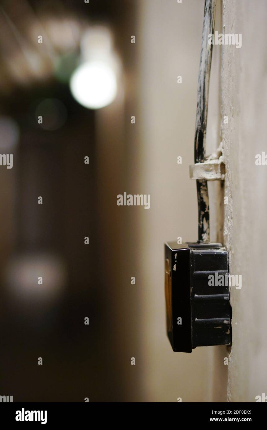 Old light switch and cable attached to a basement wall Stock Photo - Alamy