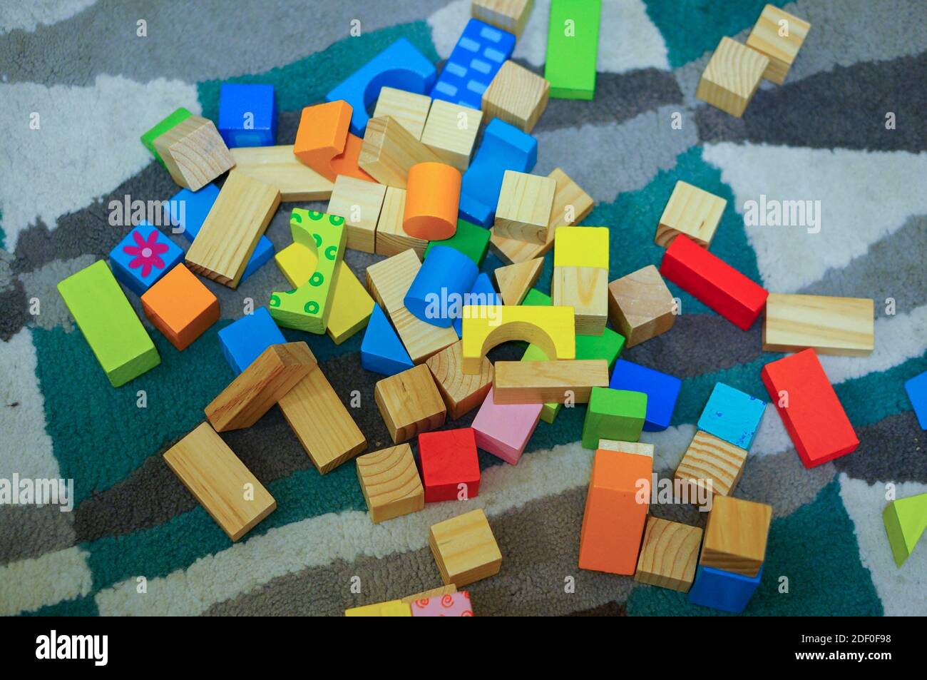 A top view of colorful wooden blocks scattered on the floor of the ...