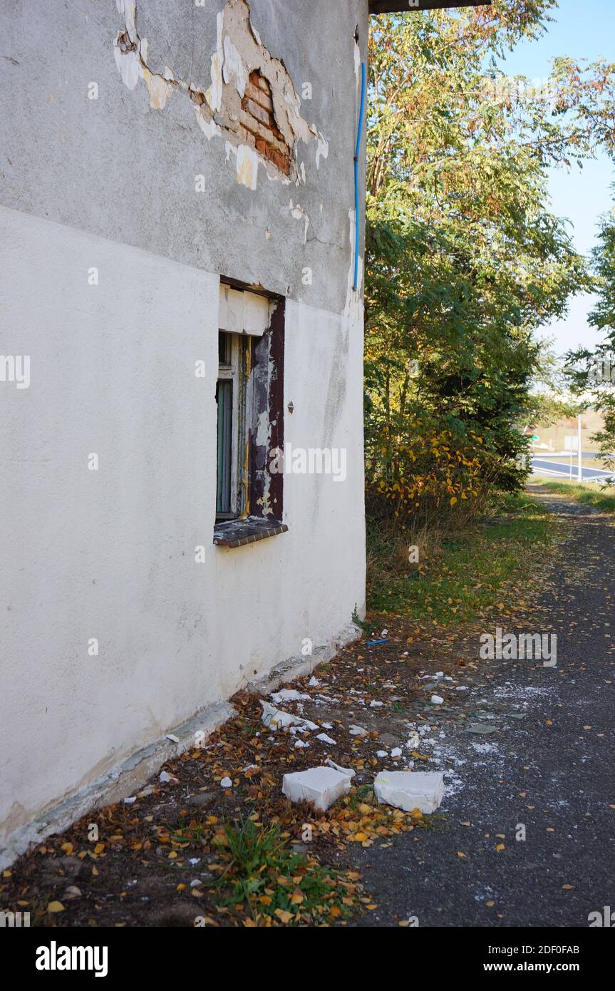 An abandoned building with cracked walls and broken window Stock Photo ...