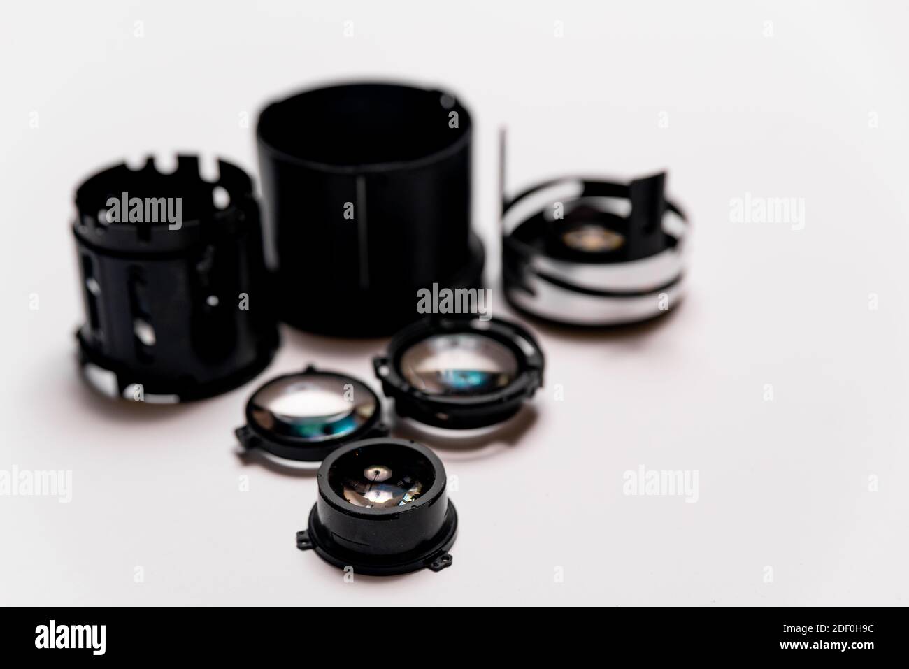 camera lens disassembled. elements and pieces of lens glass lay on ...