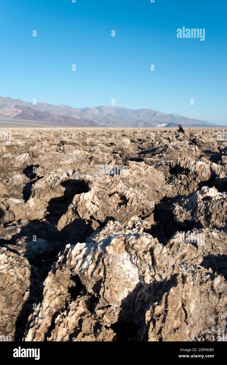 A tourist photographs the salt deposits at the Devil's Golf Course, a ...