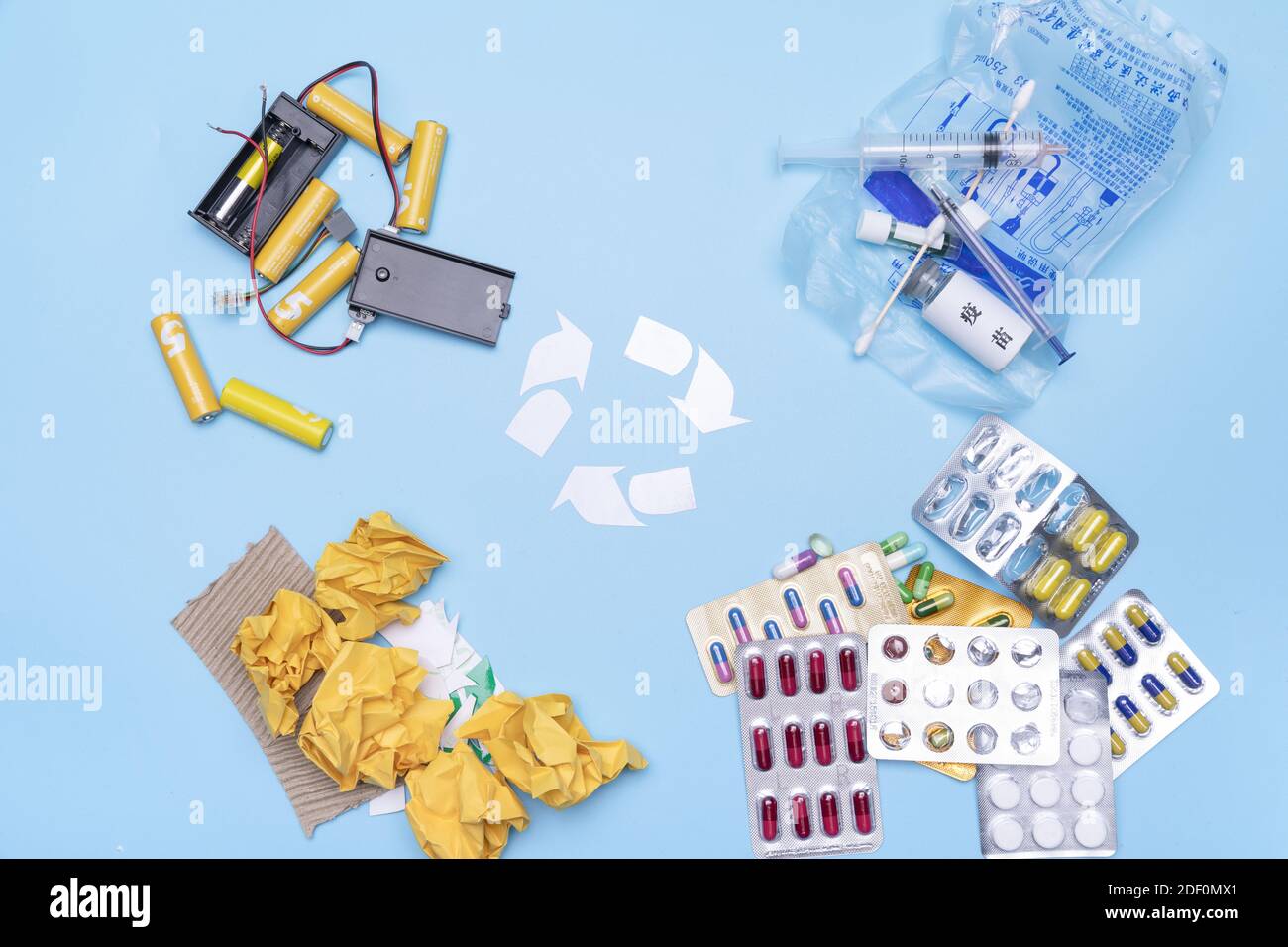 A top view of classified garbage on a blue background with a recycling ...