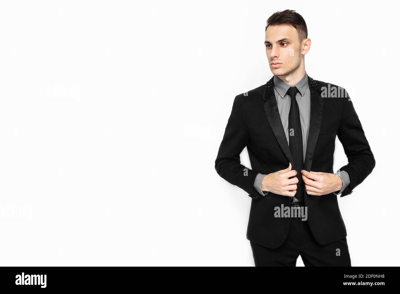 Portrait of a successful man in a black suit, a businessman posing on a ...