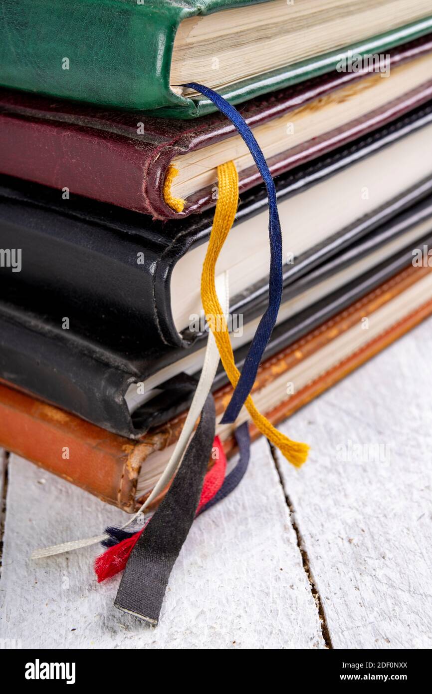 Books and notebooks with tabs made of string. Old publications with ...
