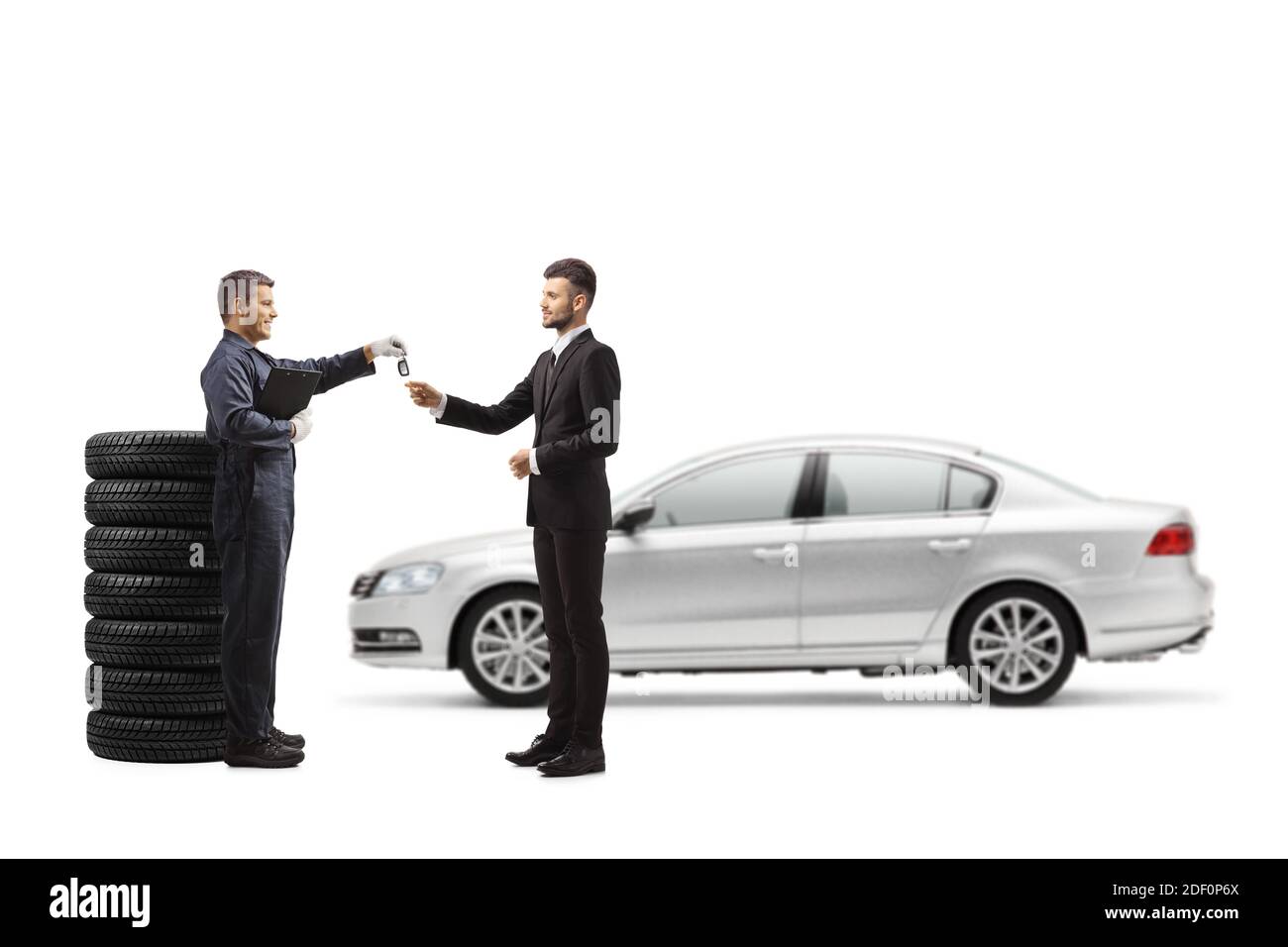 Full length profile shot of a mechanic in a uniform returning car keys ...