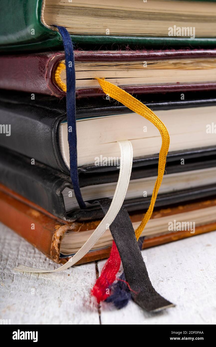 Books and notebooks with tabs made of string. Old publications with ...
