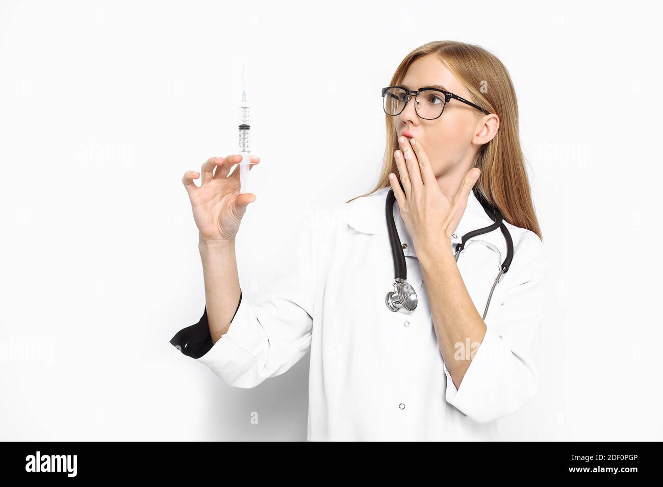 Young scared intern doctor wearing glasses with a stethoscope around ...
