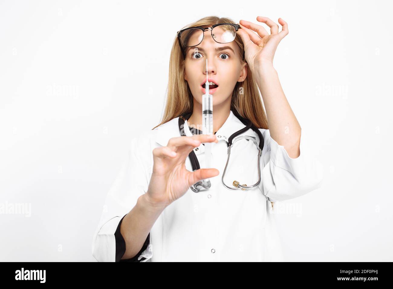Young scared intern doctor wearing glasses with a stethoscope around ...