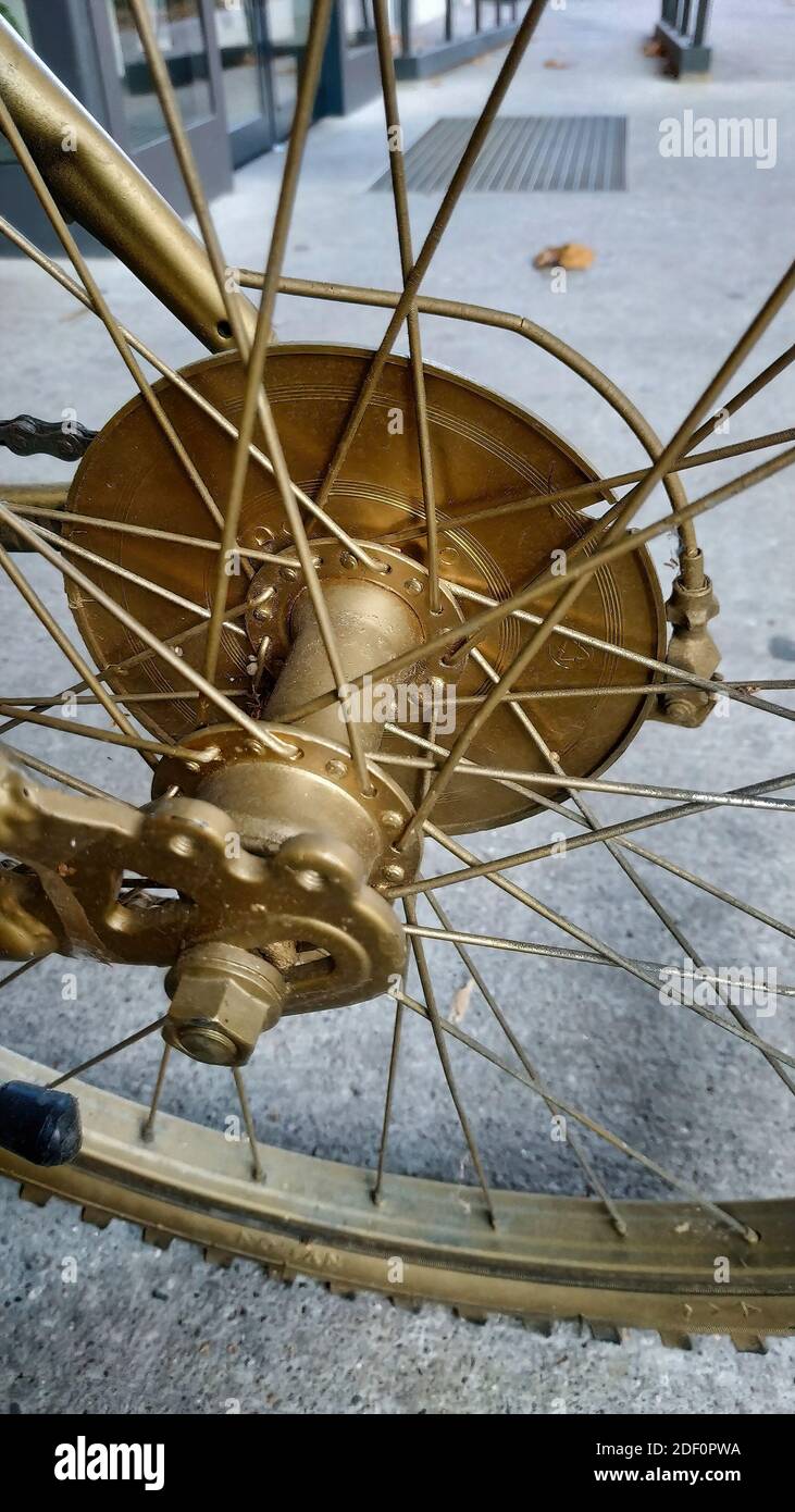A vertical closeup shot of a golden vintage bicycle tire details Stock ...