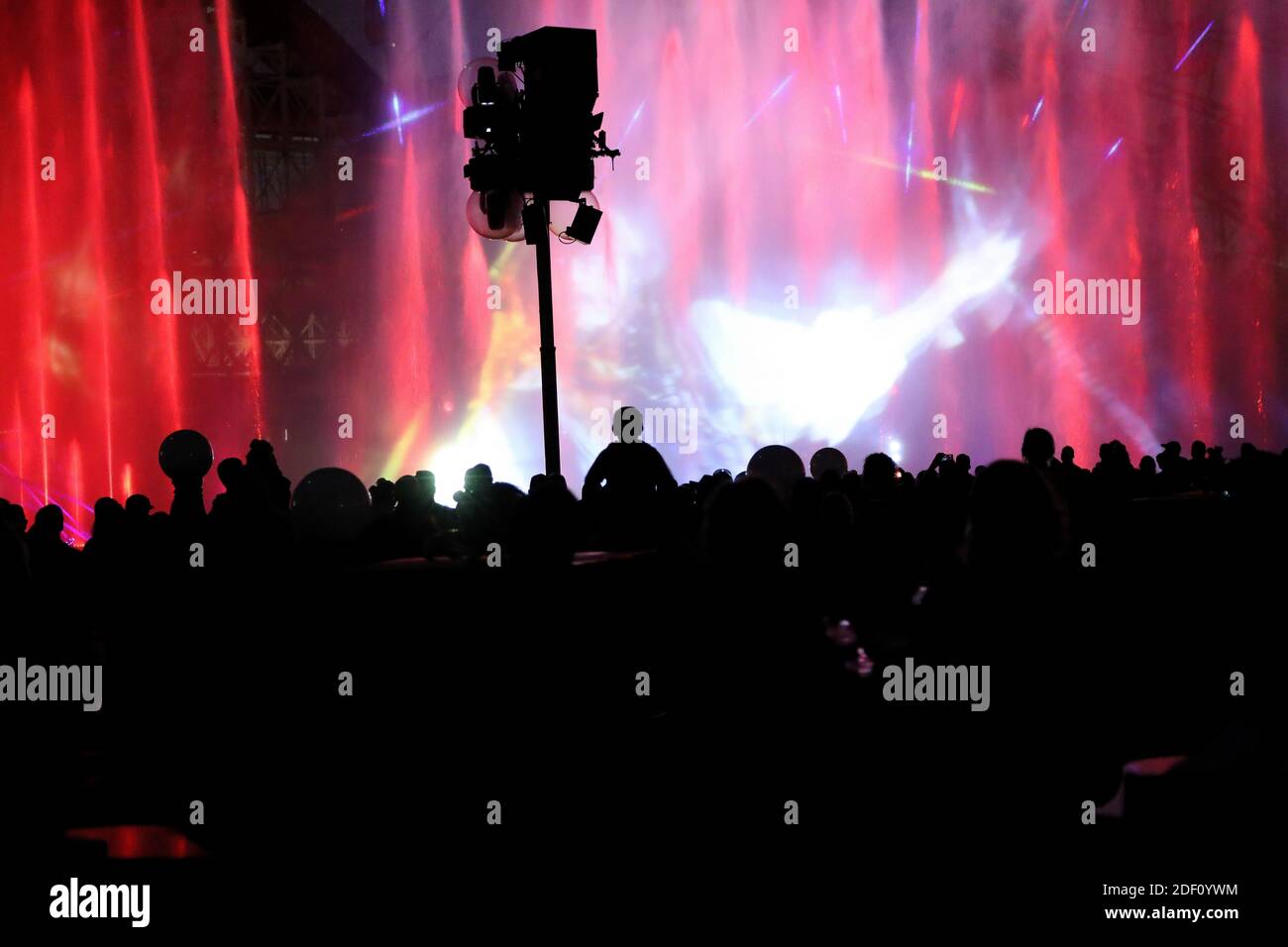Pyrotechnic light show with crowd silhouetted against the light Stock ...