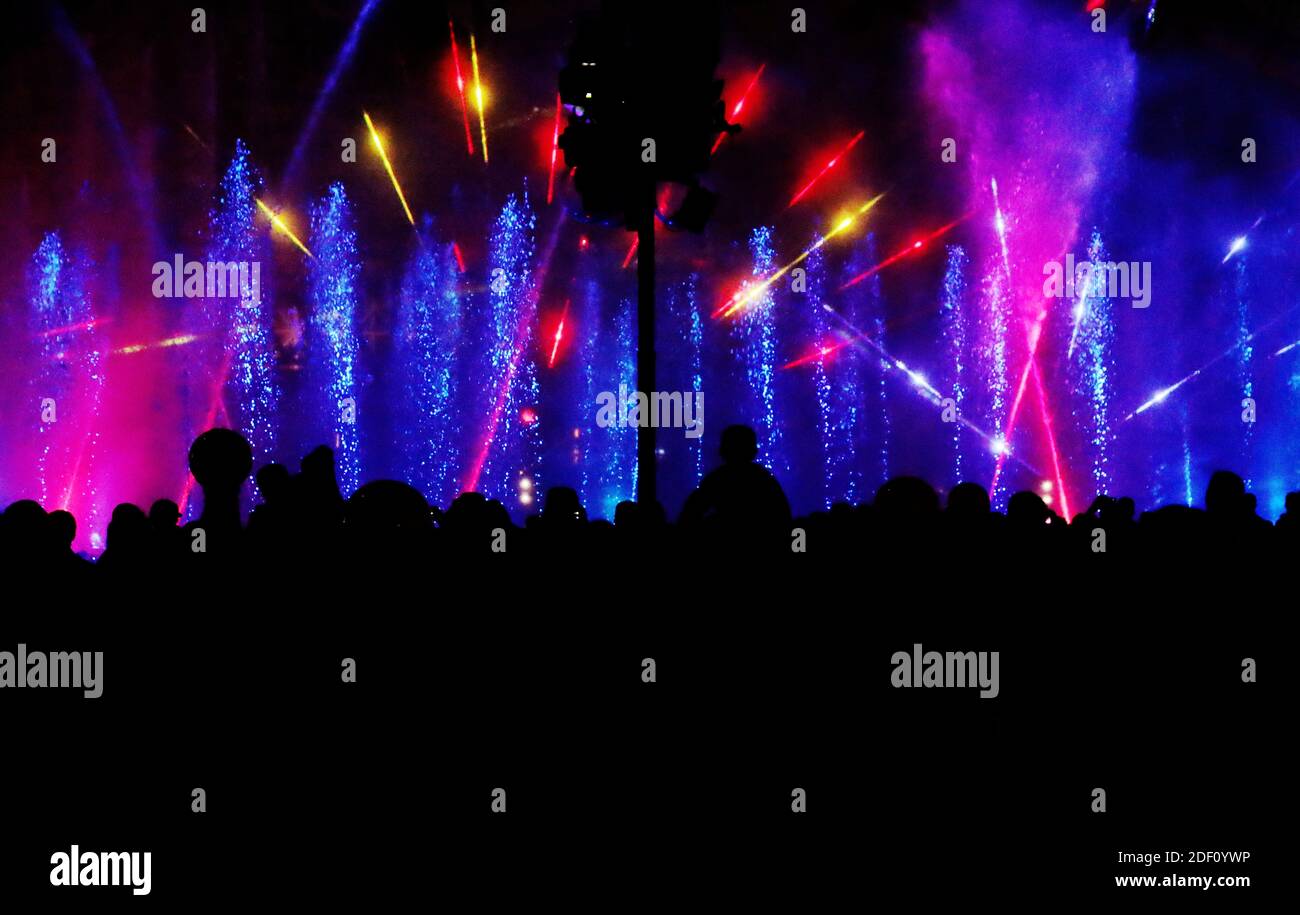 Pyrotechnic light show with crowd silhouetted against the light Stock ...