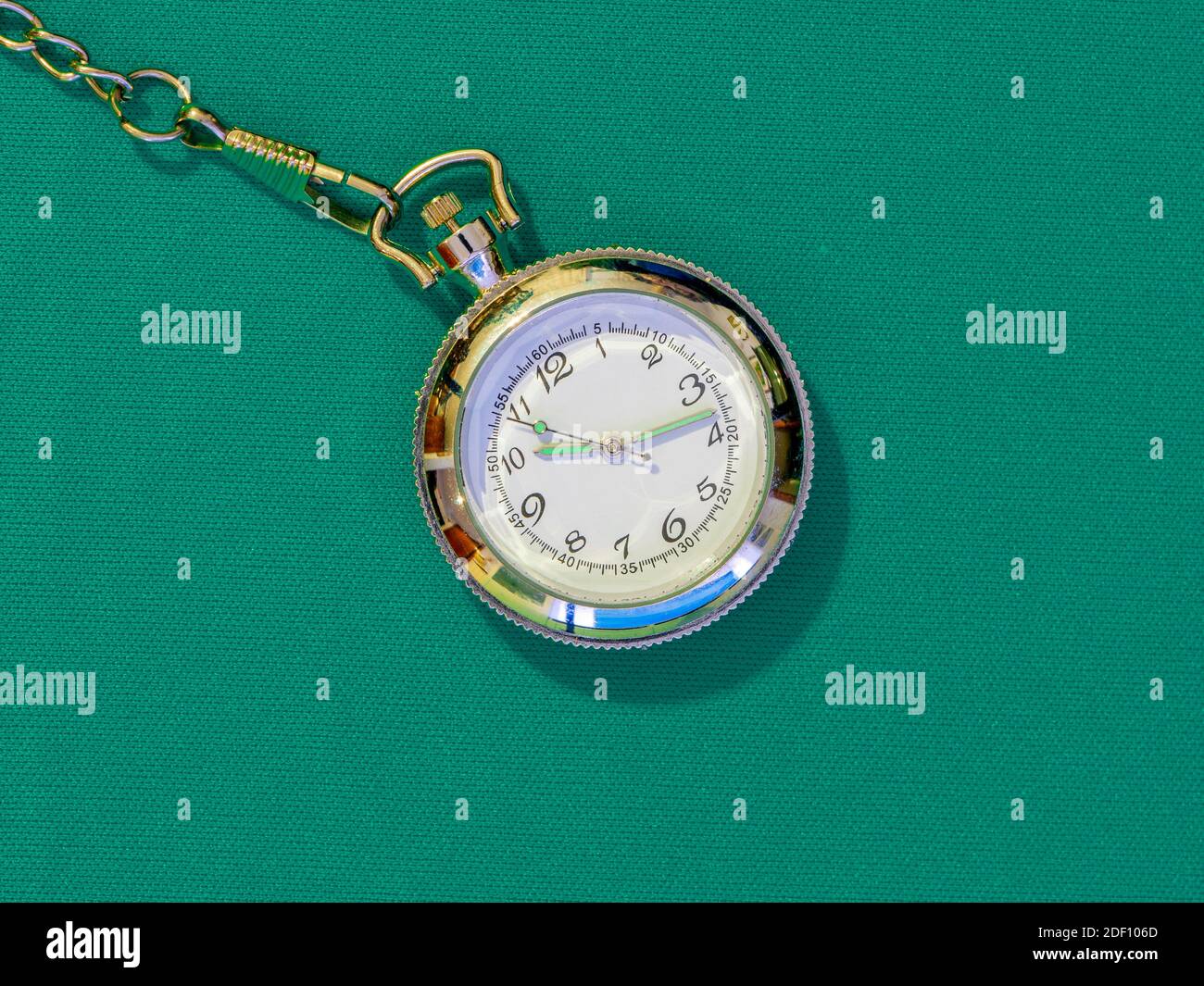 Small steel pocket watch with white dial, metal object on a uniform ...