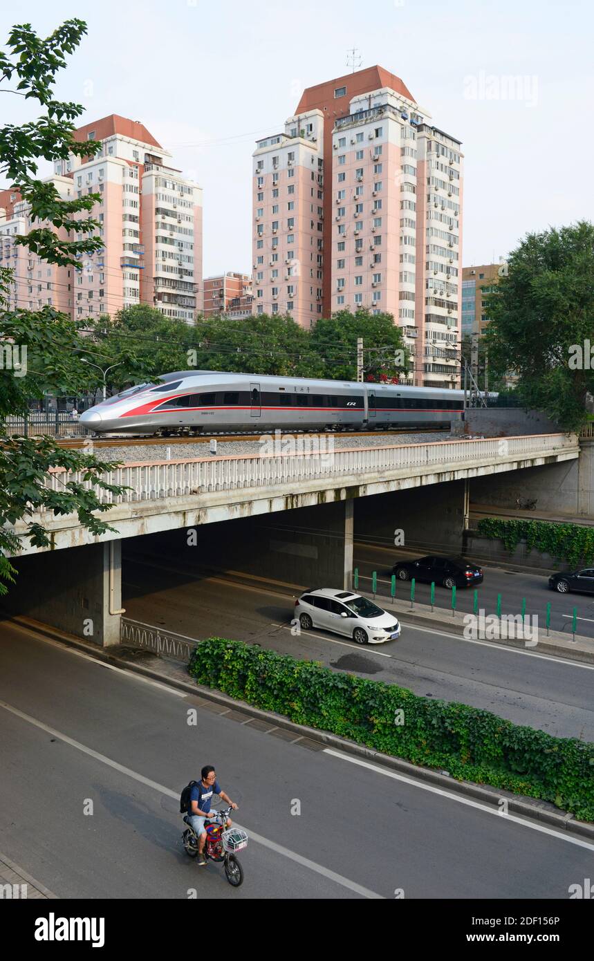 A Fuxing high speed bullet train crosses a road bridge in central ...