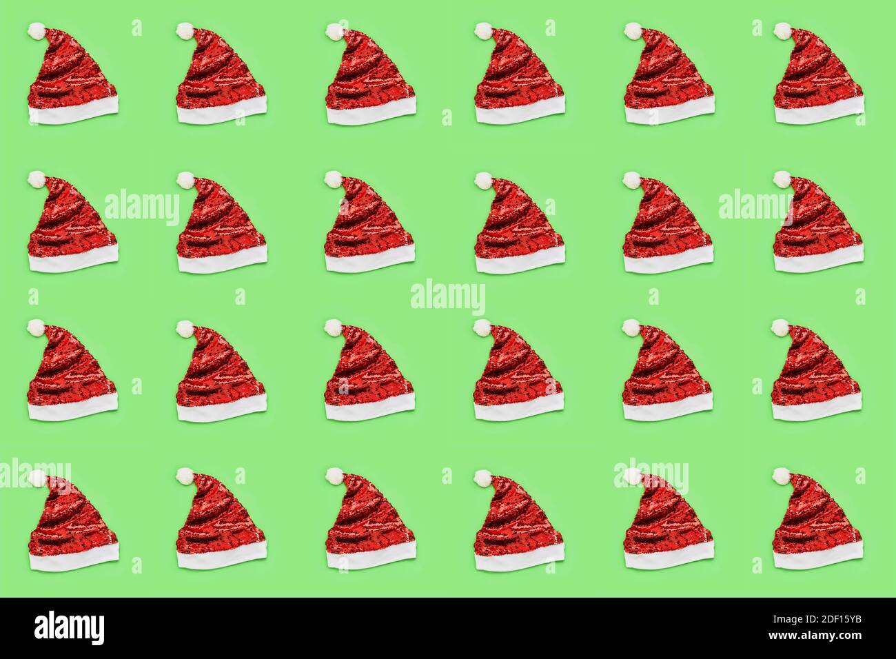 Red Sparkling Santa Claus Hat on a green background. Christmas pattern ...