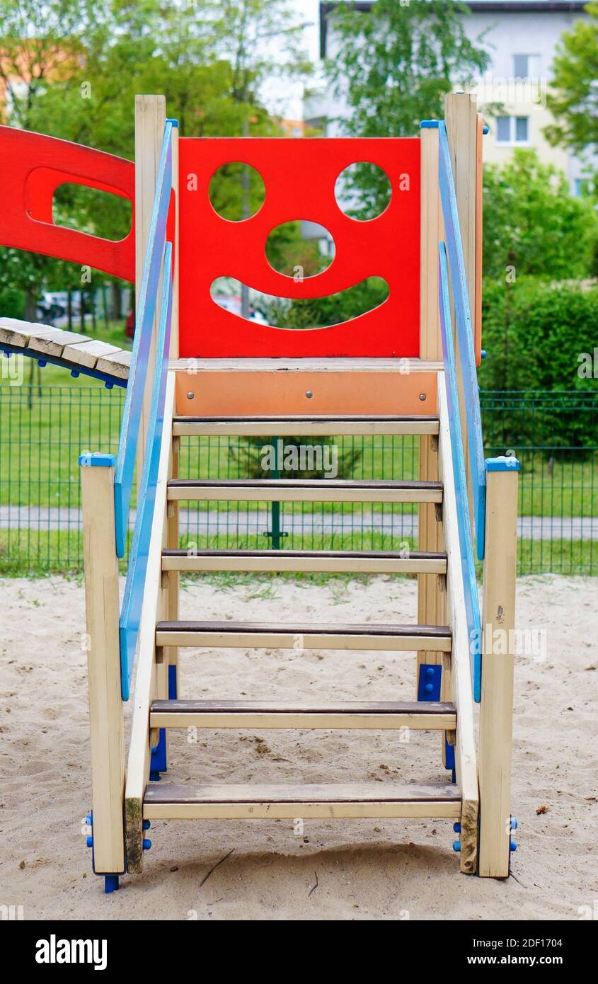 A vertical image of a wooden staircase of a children's playground set ...