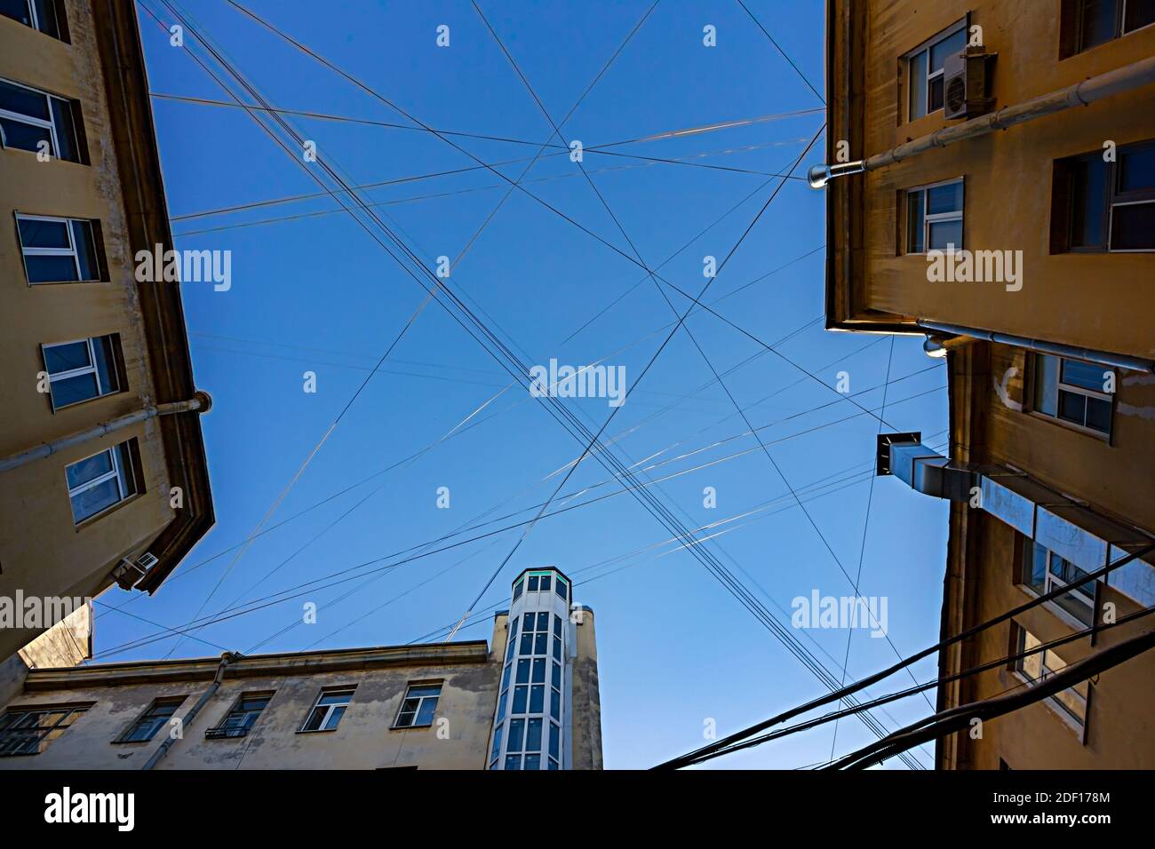 Wires in the blue sky, polluted city sky space and Cityscape ...