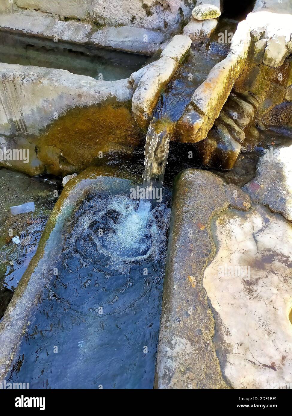 An ancient, stone-carved water trough for animals Stock Photo - Alamy