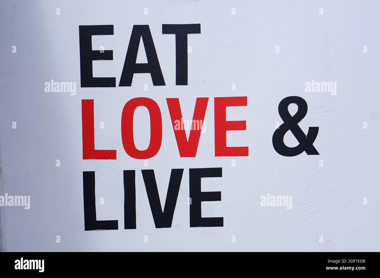 A closeup shot of a white paper with printed words of "EAT LOVE & LIVE ...