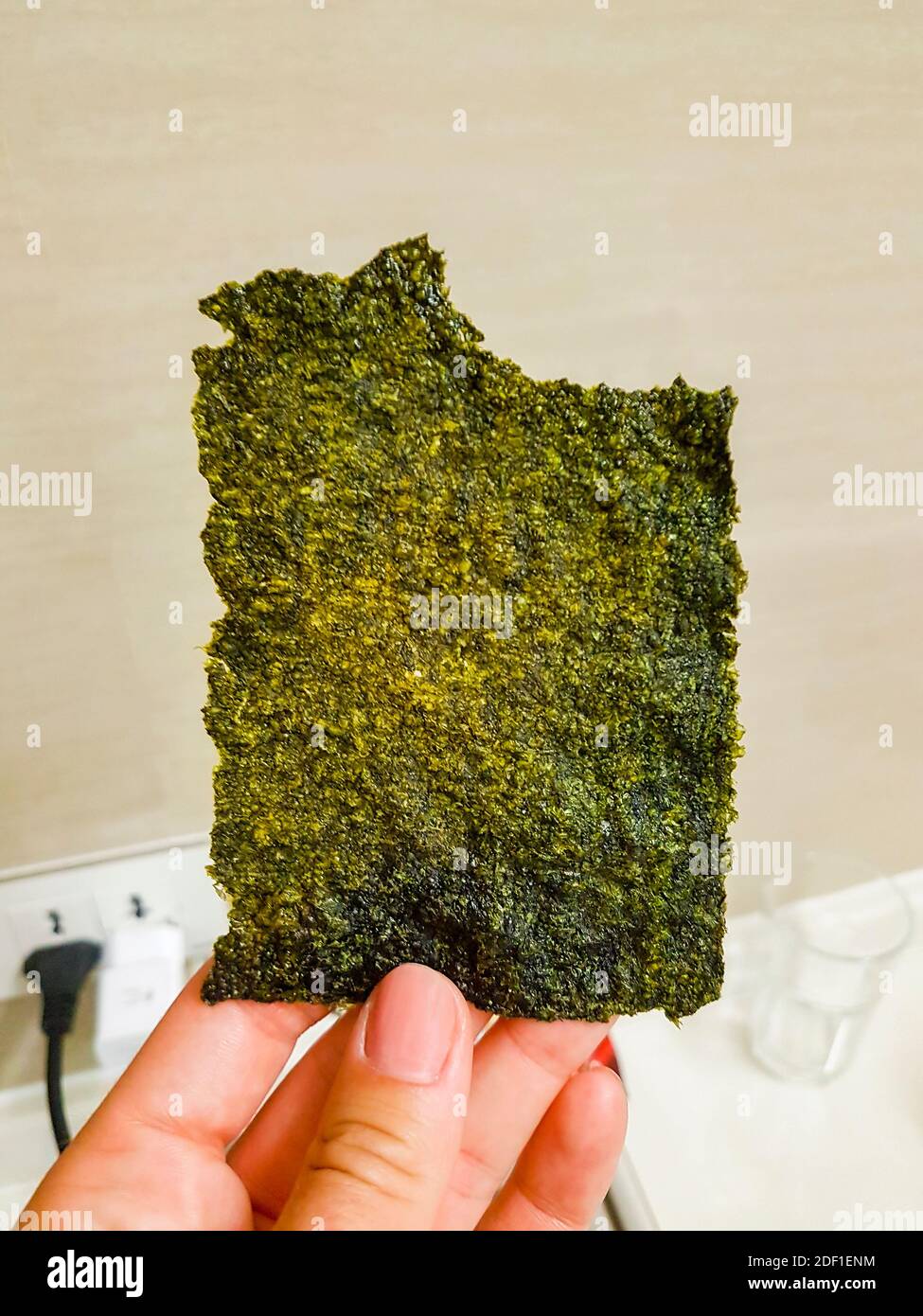 Thai seaweed instant snack unpacked hold in the hand in Thailand Stock ...