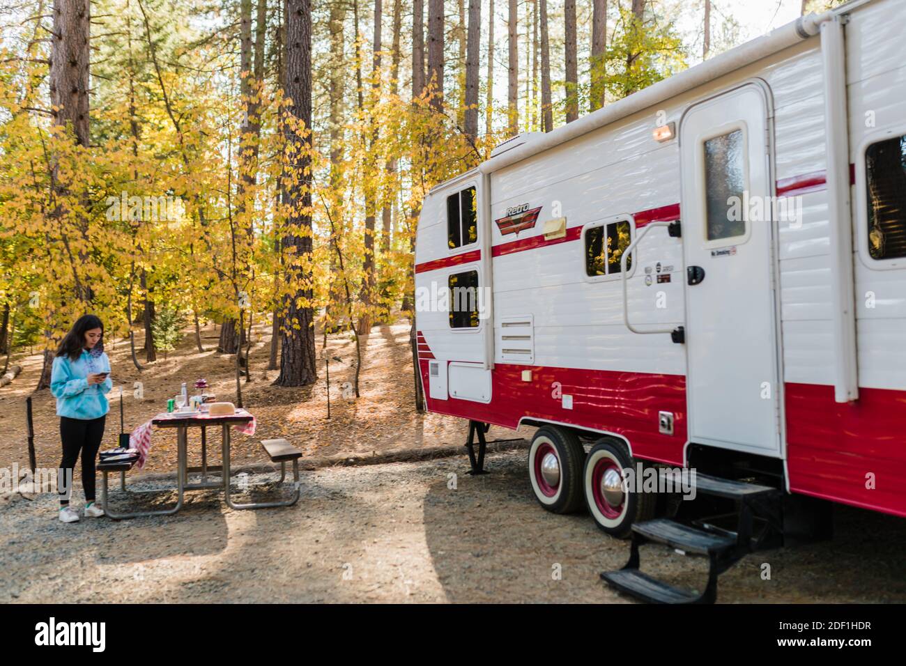 Teen by a Red and White Recreational Vehicle in the Forest for Travel ...