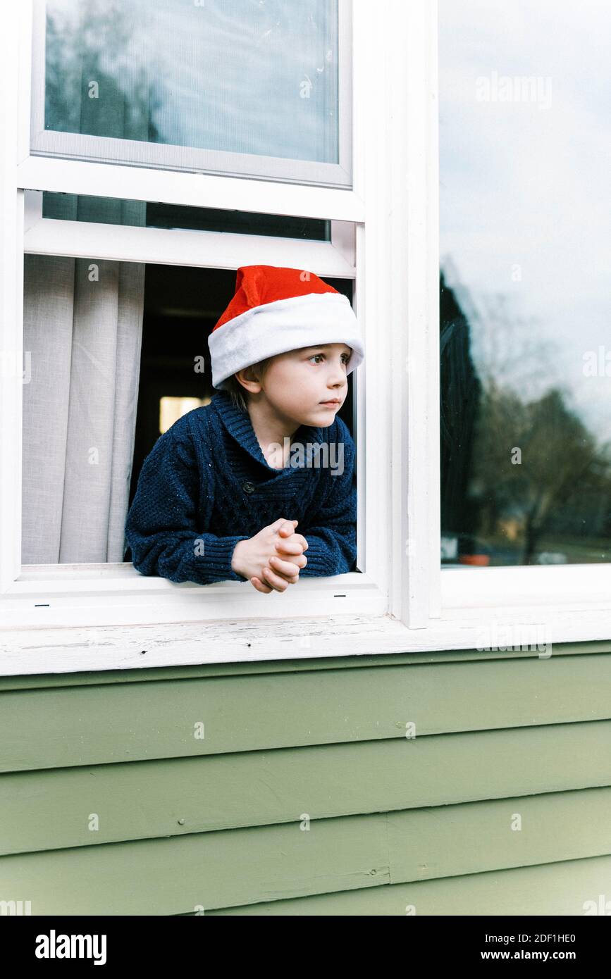 Happy children looking out of the window of their house hi-res stock ...
