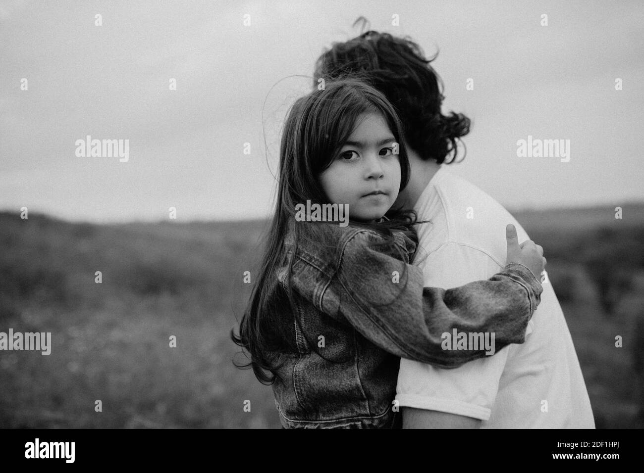 portrait of girl being carried by father in field Stock Photo - Alamy