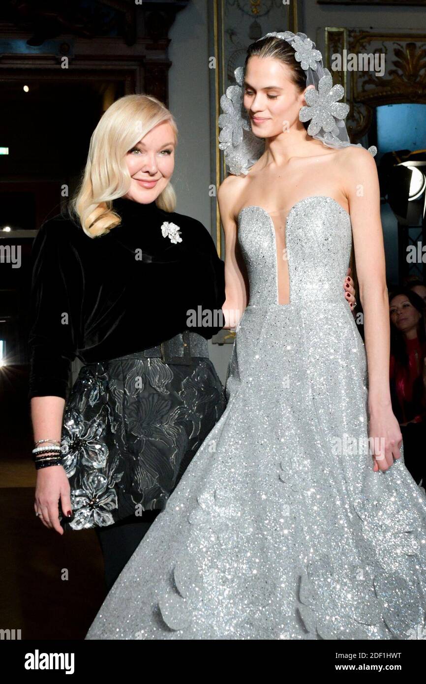 Designer Yanina and a model walk the runway during the Yanina Haute ...