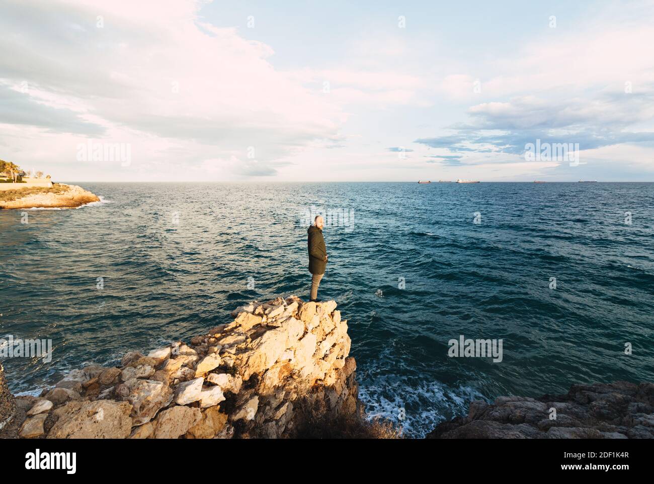 Shot Of A Man In The Center Of A Landscape Facing The Sea Stock Photo ...