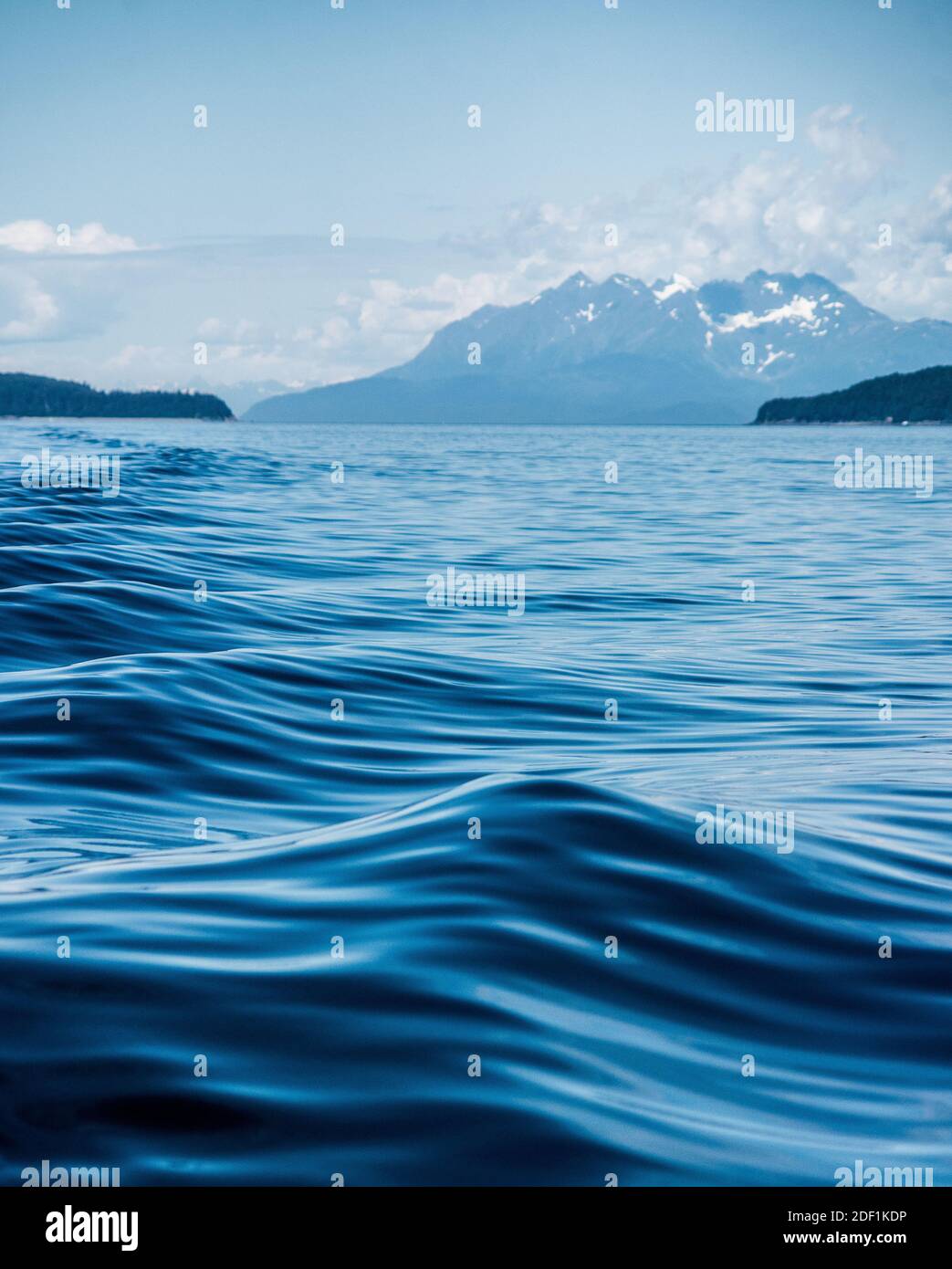 A boatâ€™s wake causes ripples and shapes on the water surface in ...