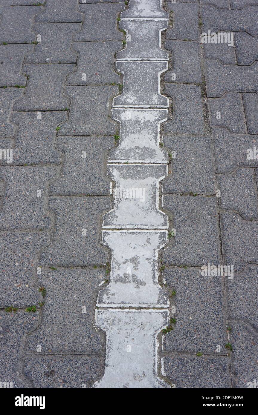 A cobblestone pathway with distinctive white line Stock Photo - Alamy
