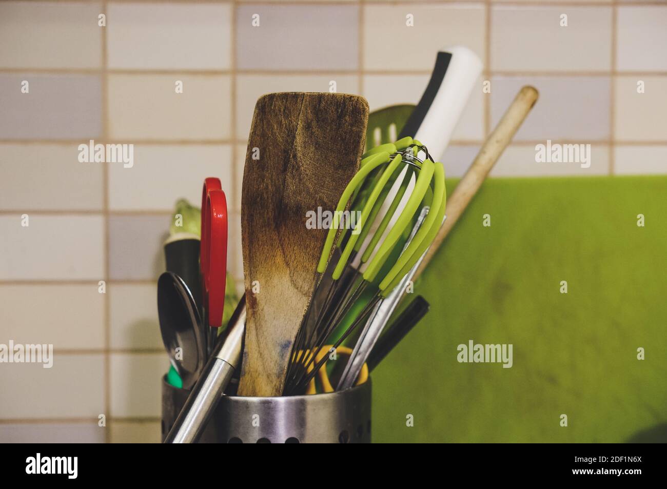 The different kitchen tools in a metal container on the table Stock ...