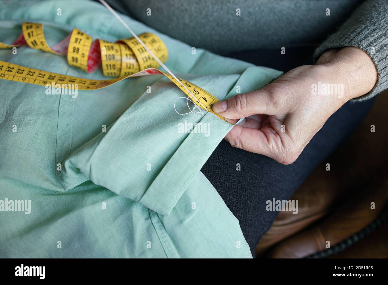 Old woman sewing and using a meter at home Stock Photo - Alamy