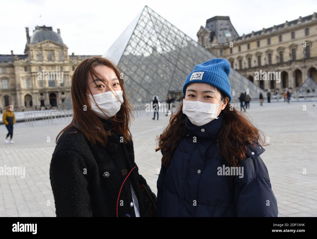 Chinese tourists wear face mask near the Louvre Museum in Paris, France ...