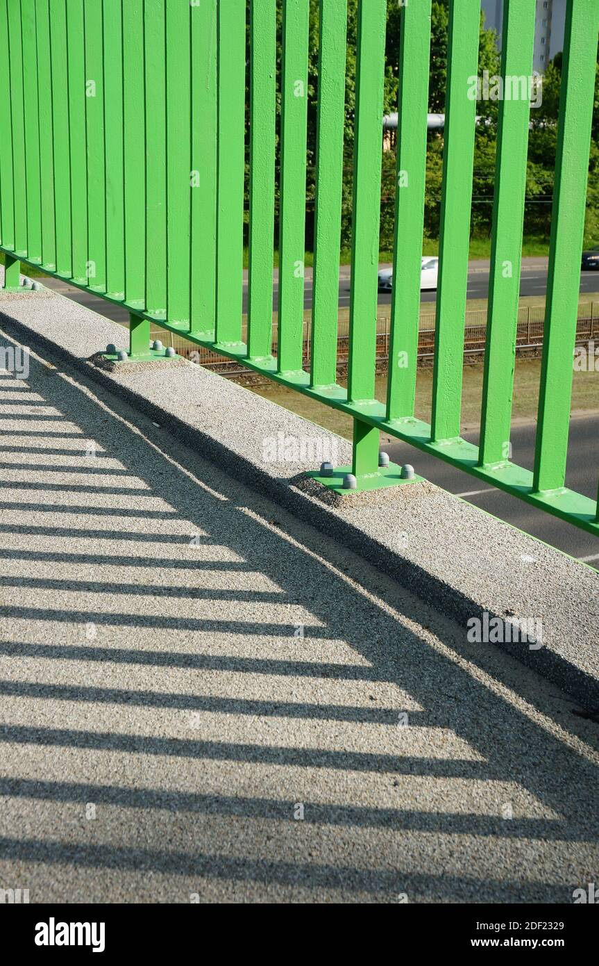 A closeup of the base of the green barrier of an overpass bridge Stock ...