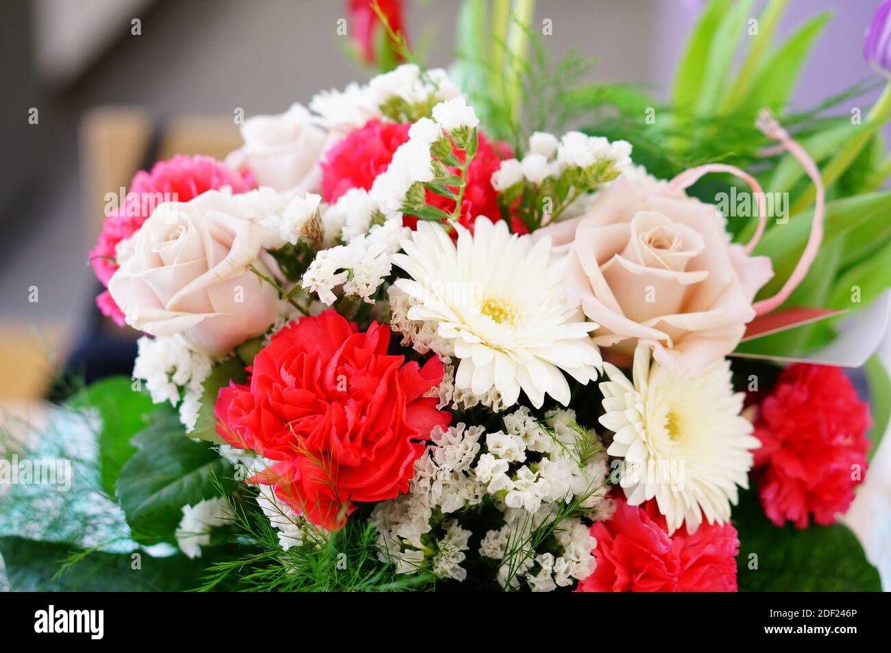 A closeup of a beautiful bouquet of flowers composed of roses, statice ...