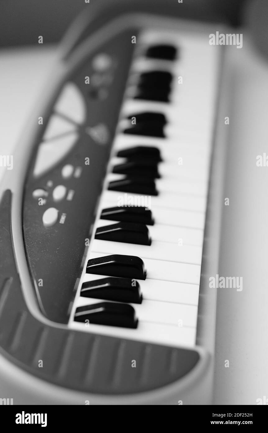 A grayscale vertical shot of a small keyboard Stock Photo - Alamy