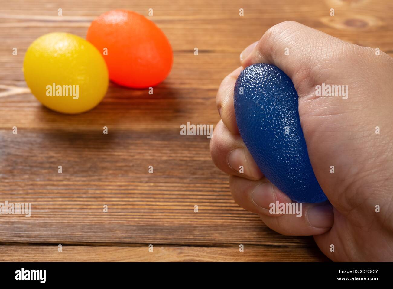 man doing exercises by squeezing a rubber hand trainer Stock Photo - Alamy