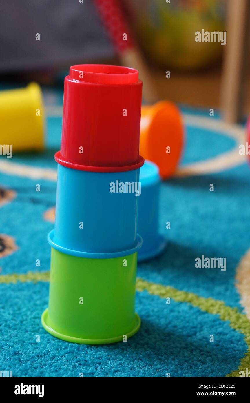 A stack of plastic toy cups on a rug Stock Photo - Alamy