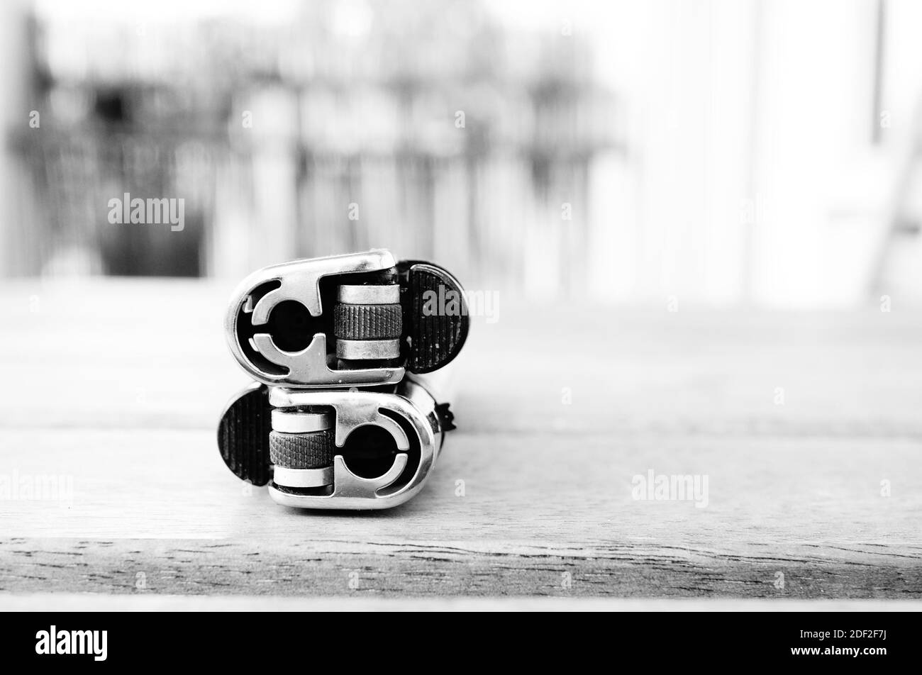 A selective focus shot of two lighters stacked on top of each other in ...
