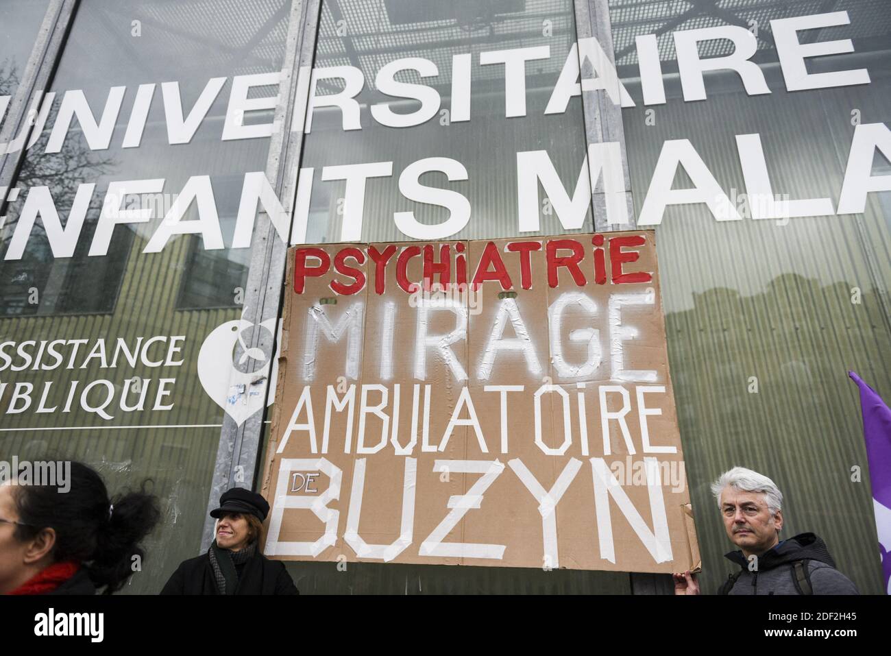 Healthcare workers wearing masks depicting French President and French ...