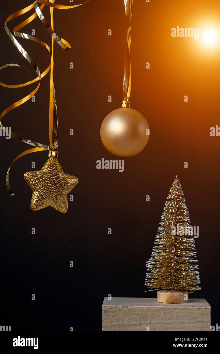 Golden winter tree with Christmas balls and sparkling lights in xmas ...