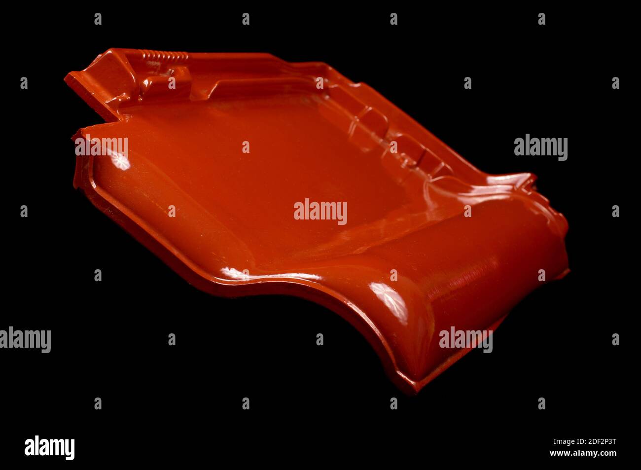 Single new shinny red roof tile isolated on the black background Stock ...