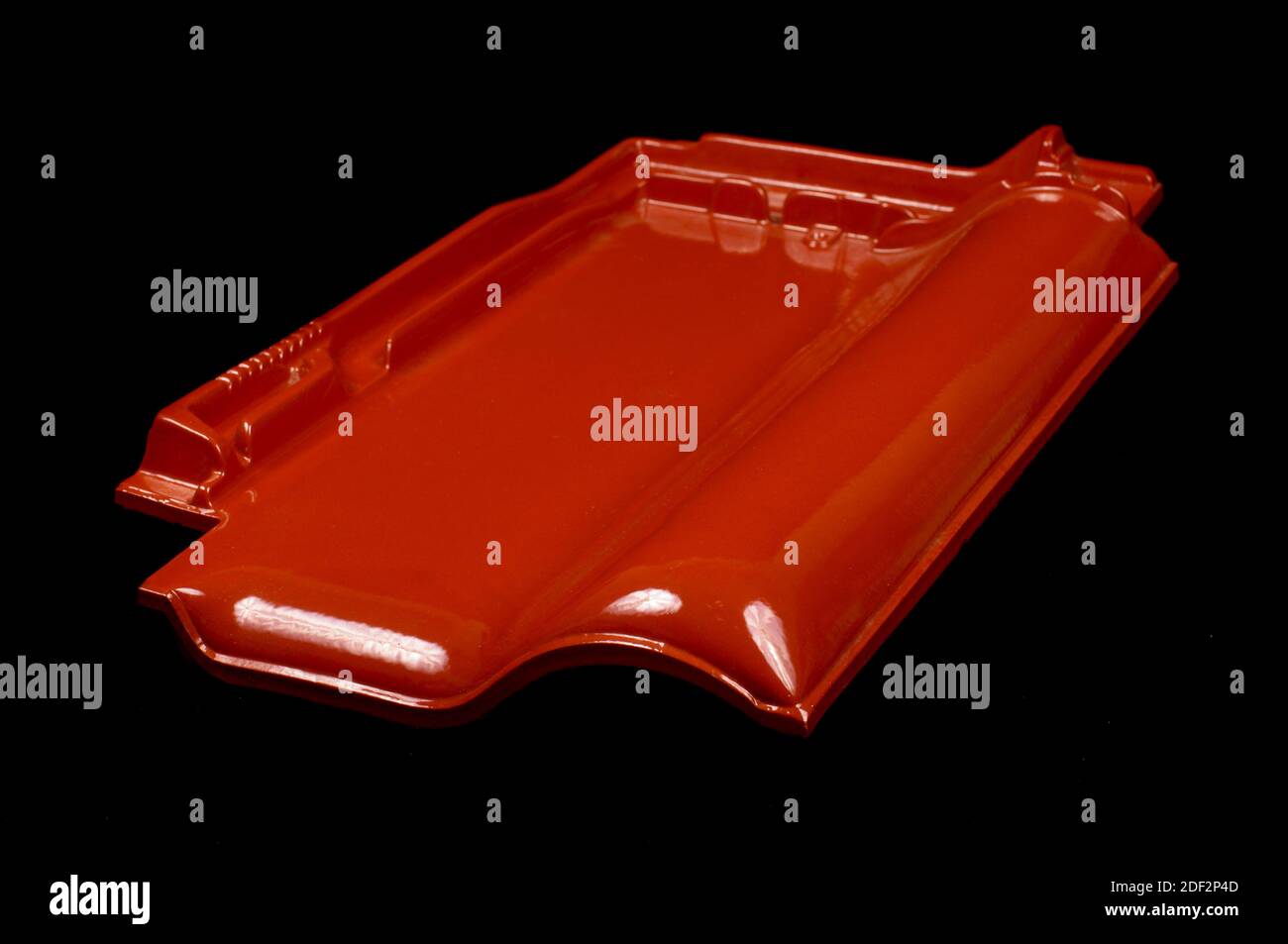 Single new shinny red roof tile isolated on the black background Stock ...