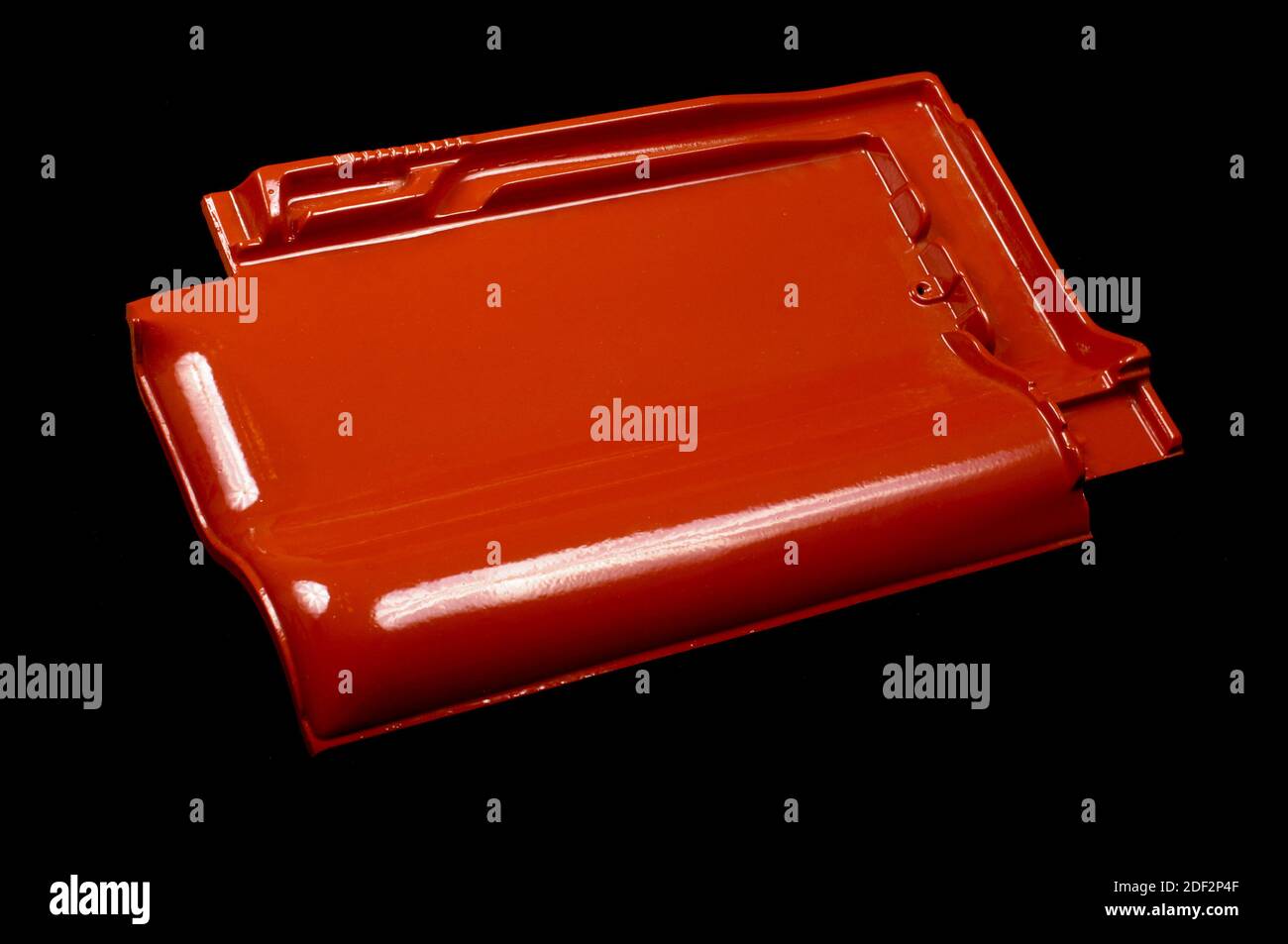 Single new shinny red roof tile isolated on the black background Stock ...