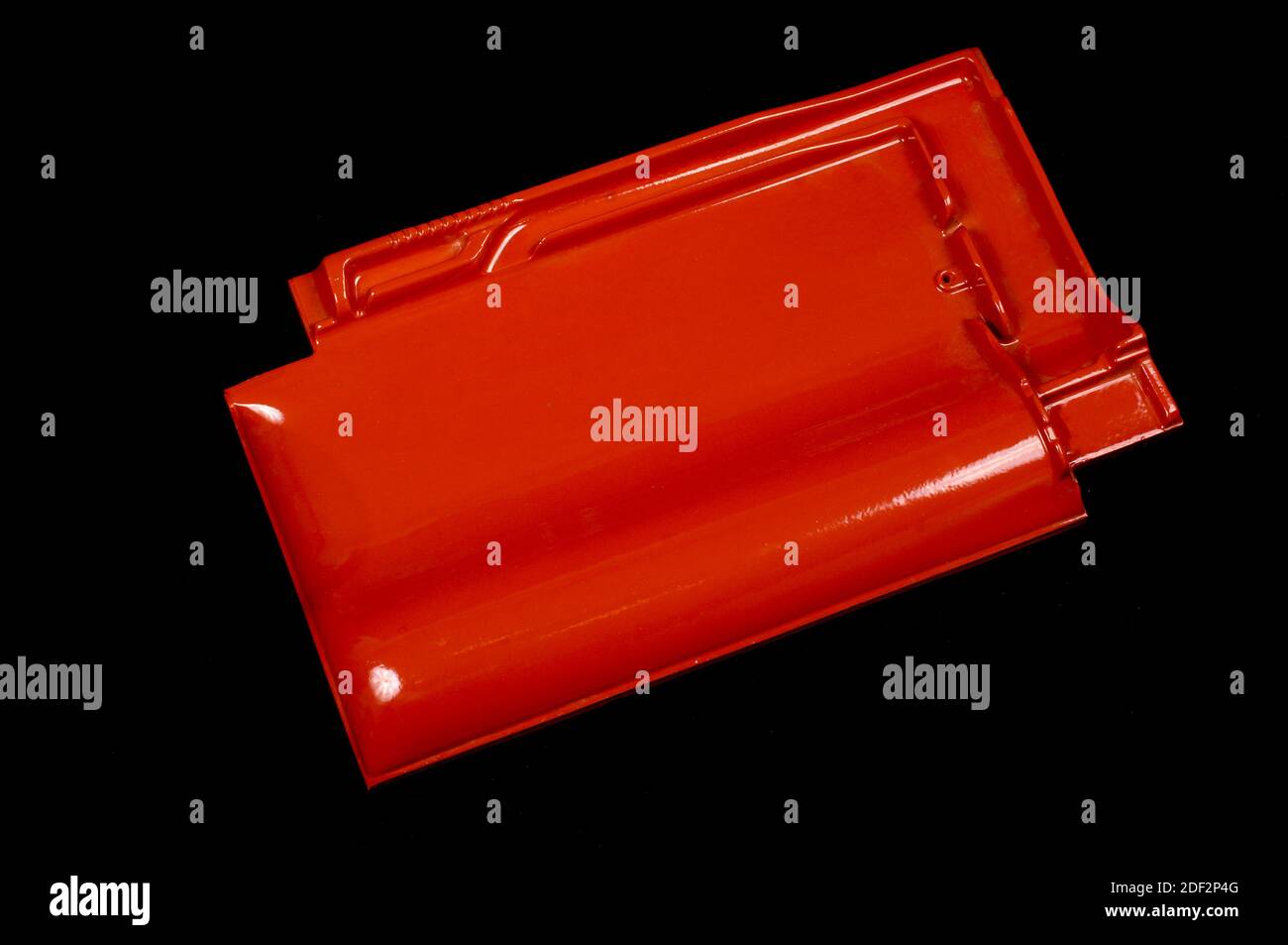 Single new shinny red roof tile isolated on the black background Stock ...