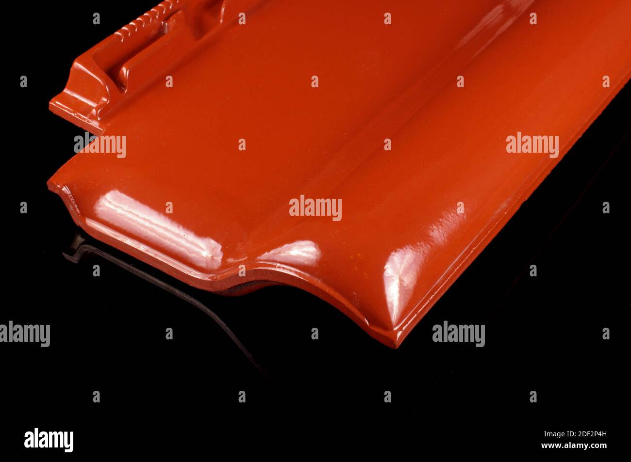 Single new shinny red roof tile isolated on the black background Stock ...